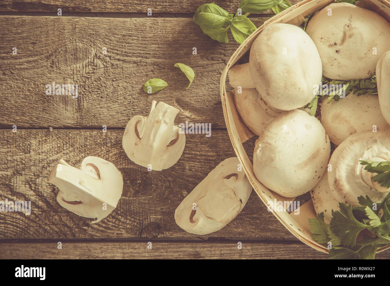 Mushrooms on rustic wood background Stock Photo - Alamy
