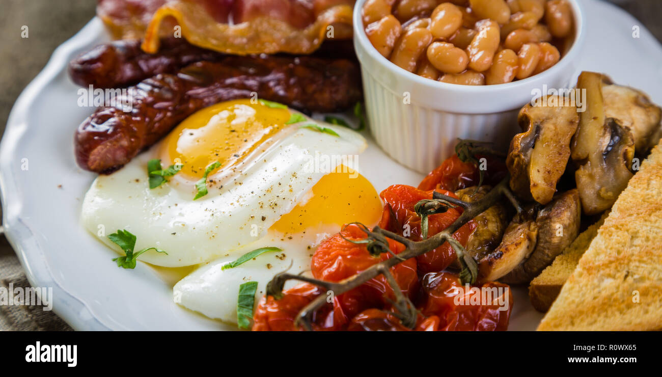 Full english breakfast - eggs, bacon, beans, toast, coffee and juice ...