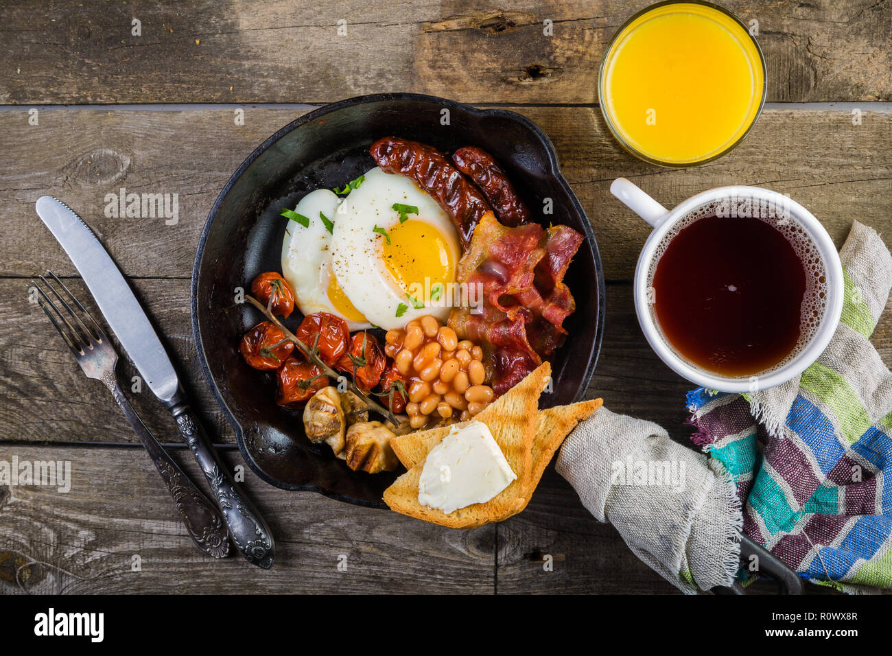 Full english breakfast - eggs, bacon, beans, toast, coffee and juice ...