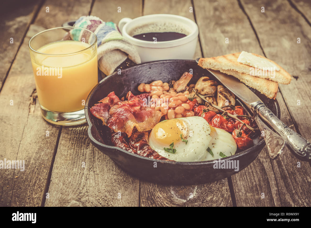 Full english breakfast - eggs, bacon, beans, toast, coffee and juice ...
