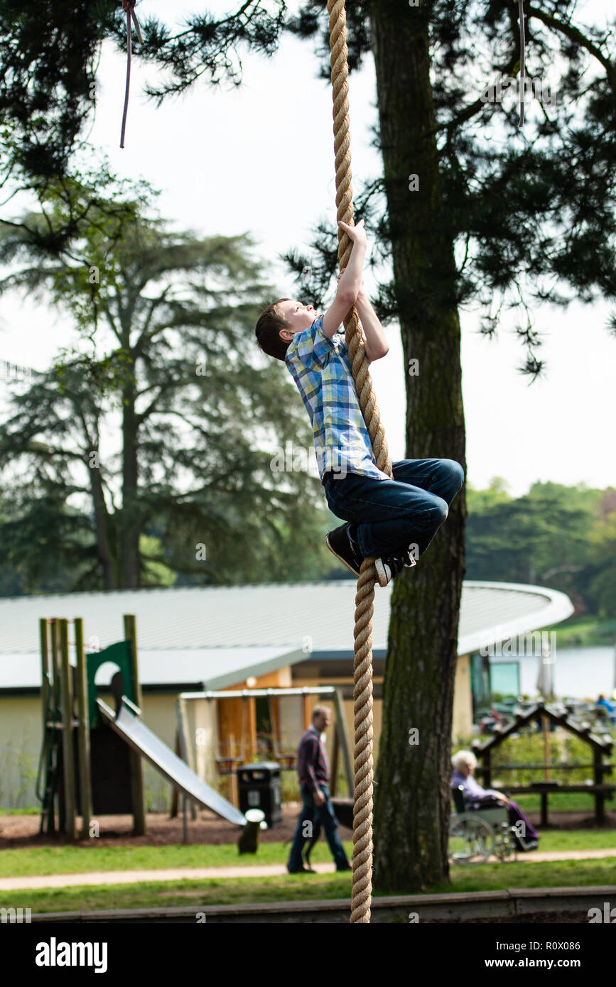 An active, fit boy with ADHD, Autism, Aspergers Syndrome rope climbing ...