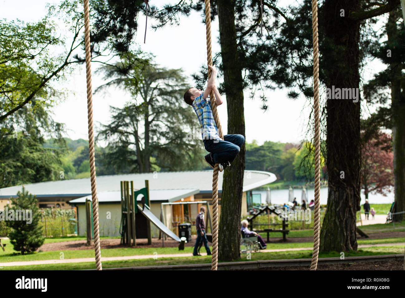 An active, fit boy with ADHD, Autism, Aspergers Syndrome rope climbing ...