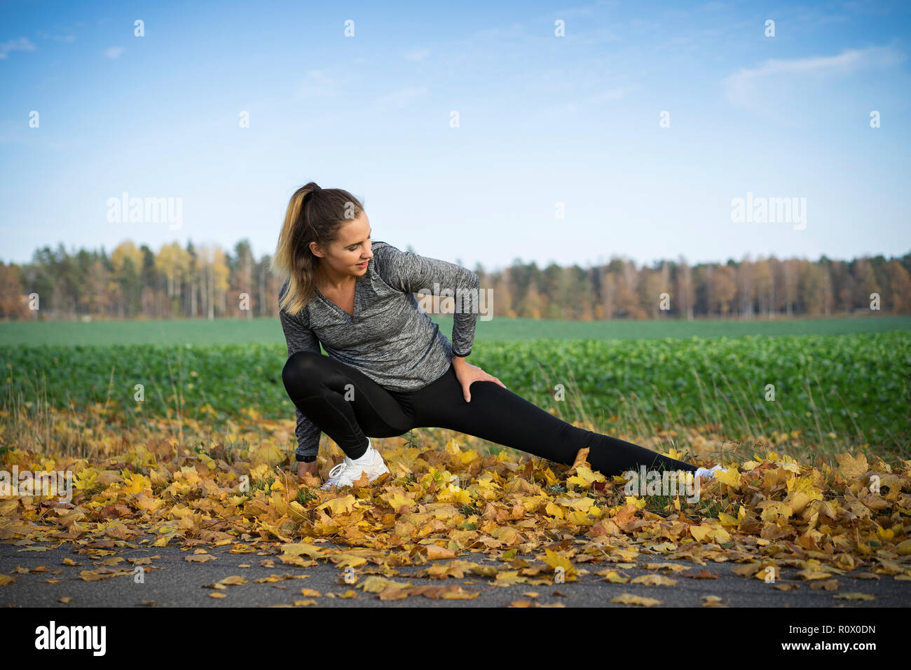 Caucasian blonde Scandinavian fitness girl outdoors in Sweden ...