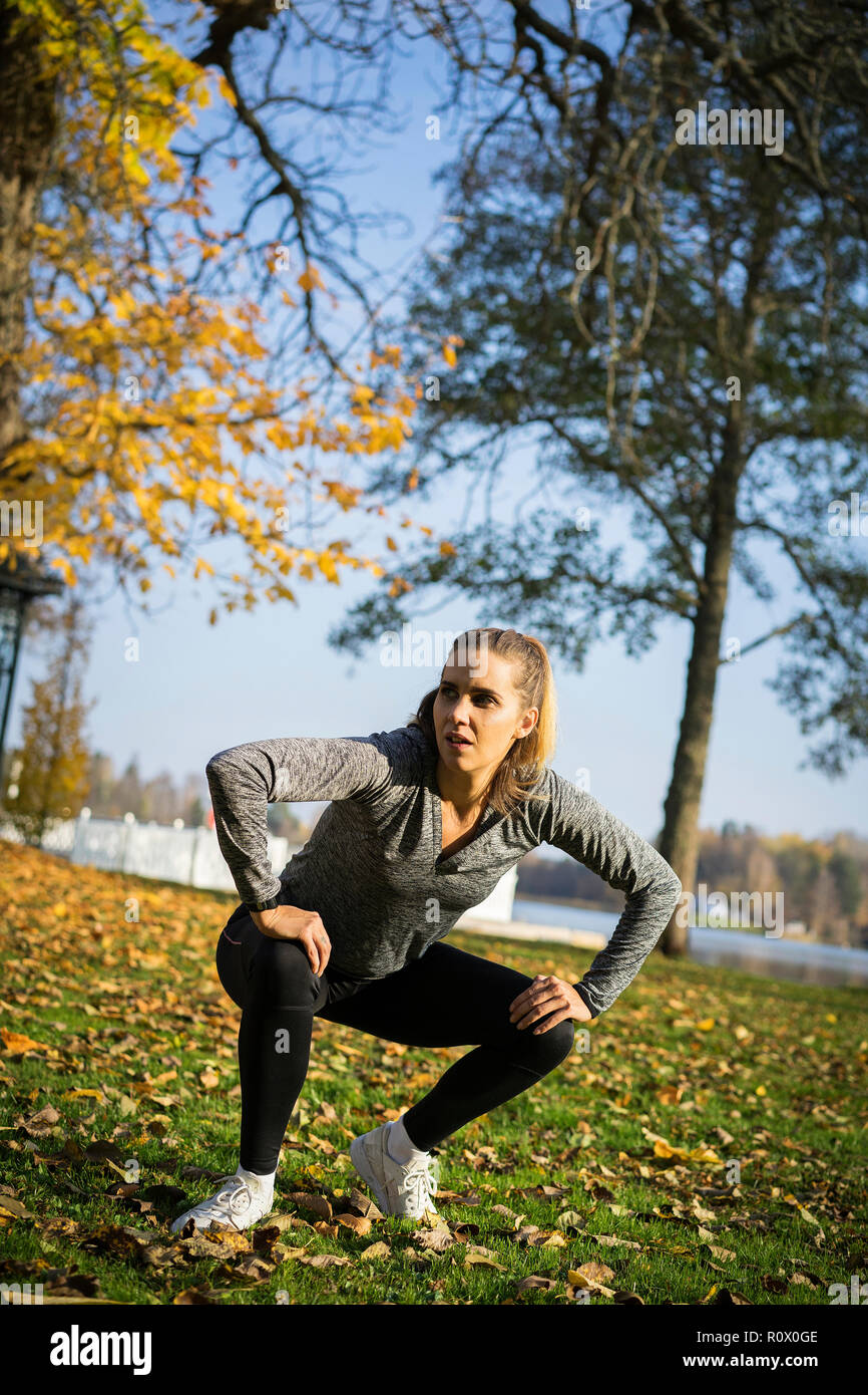 Caucasian blonde Scandinavian fitness girl outdoors in Sweden ...