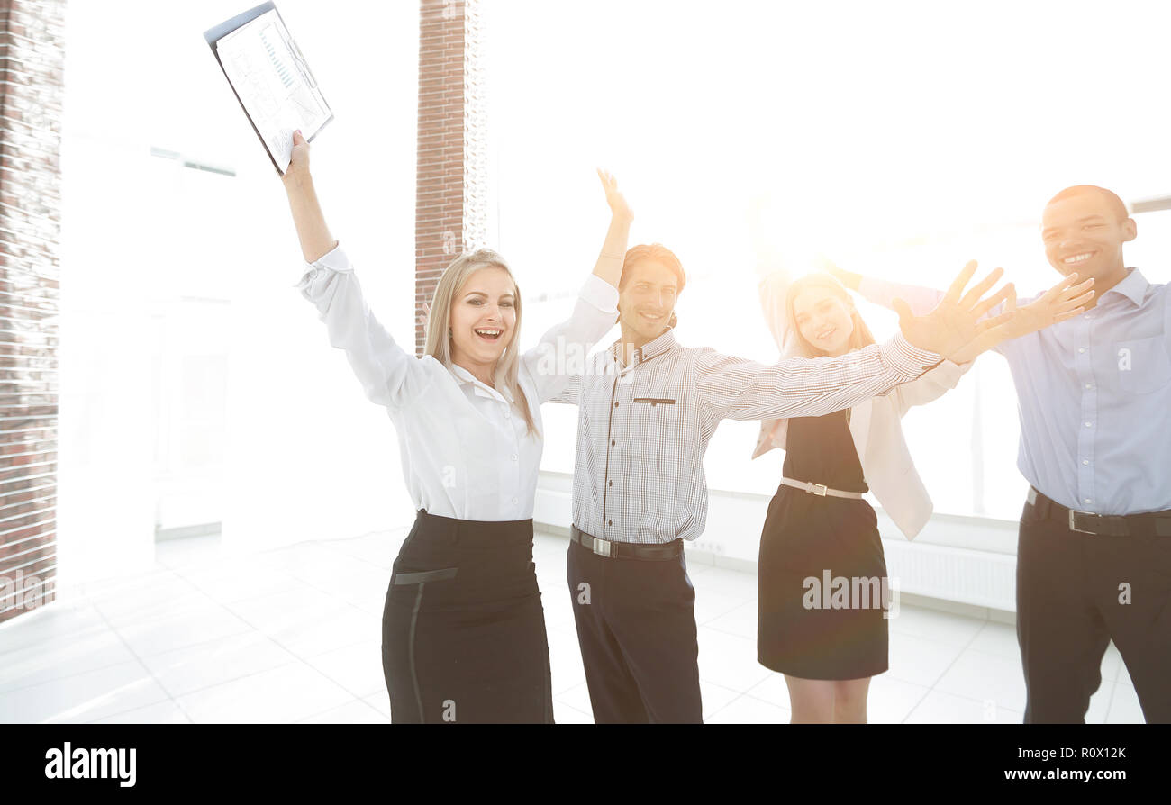 happy business team in the background of the office.the concept of ...