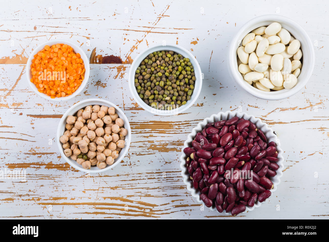 Selection of colorful beans on white wood background Stock Photo - Alamy