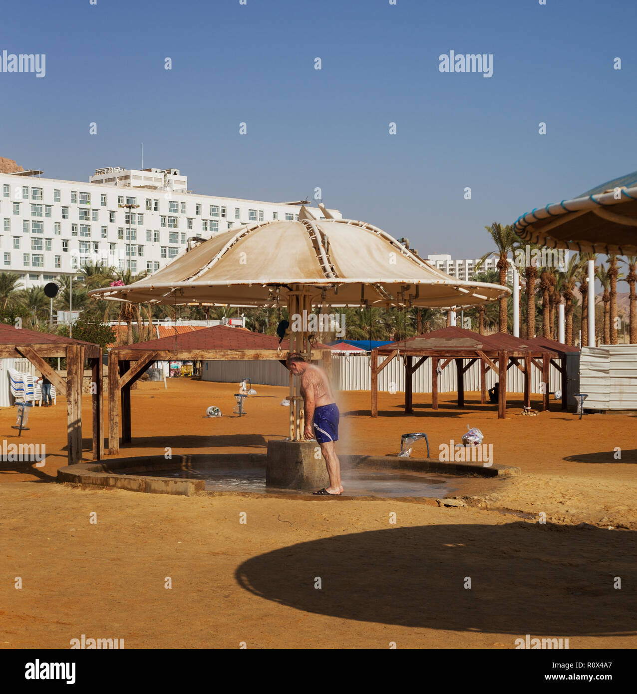Man is washed in the shower on the beach of Dead sea, Israel Stock ...