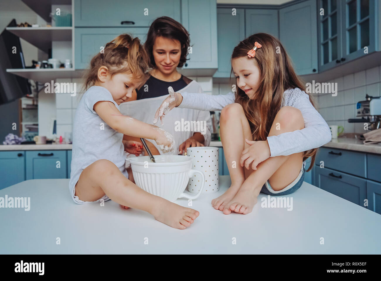 Happy family cook together in the kitchen Stock Photo - Alamy