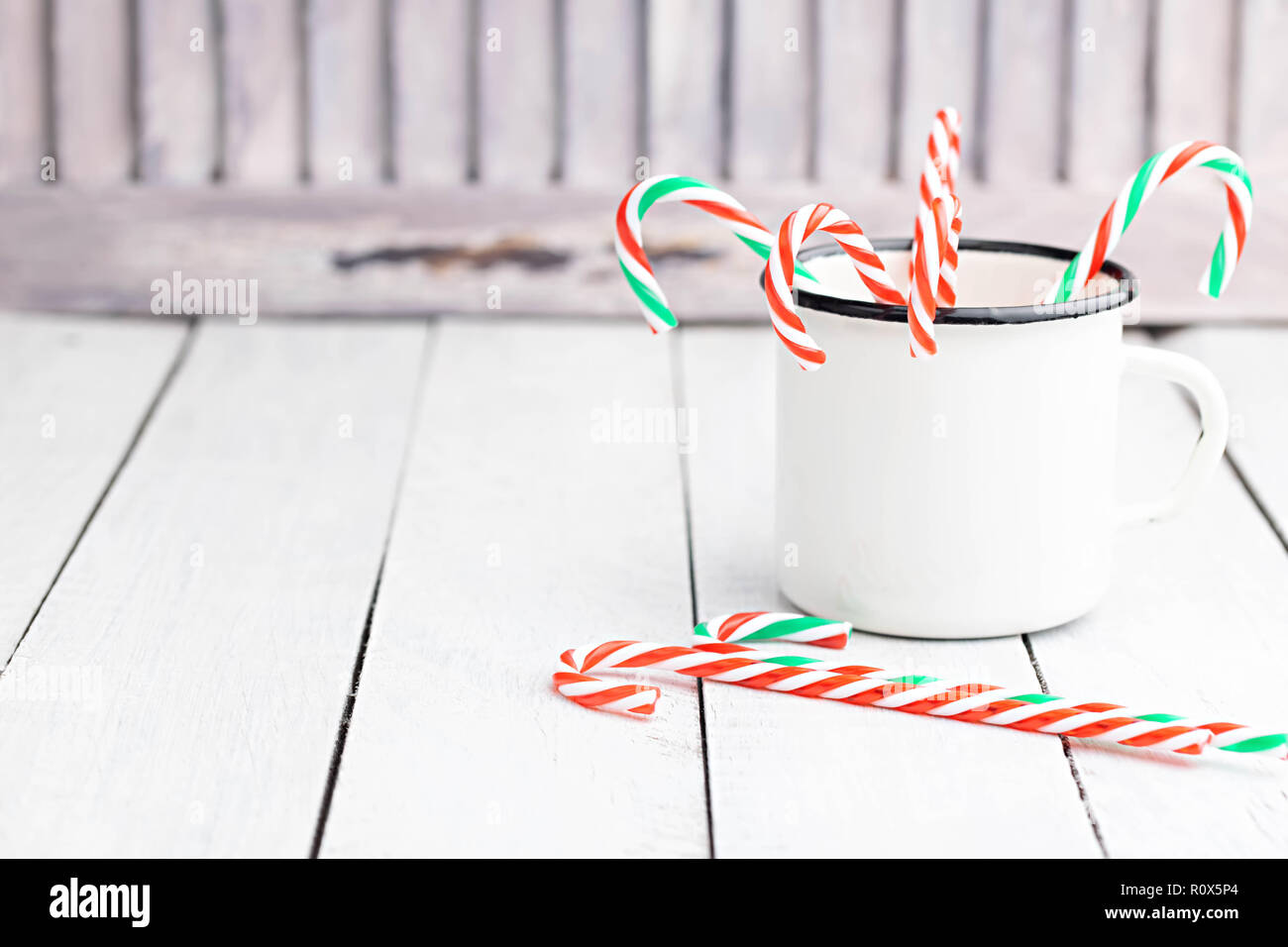 Christmas candy cane sticks in white tin cup. Light coloured photo ...