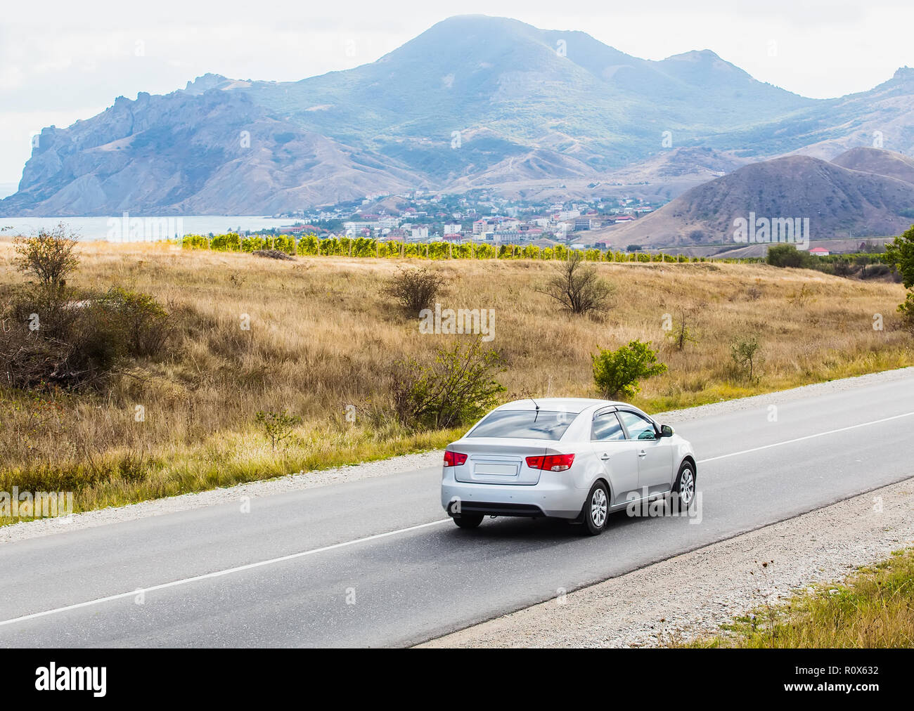Beautiful scenery with mountains, lake, road and car Stock Photo - Alamy