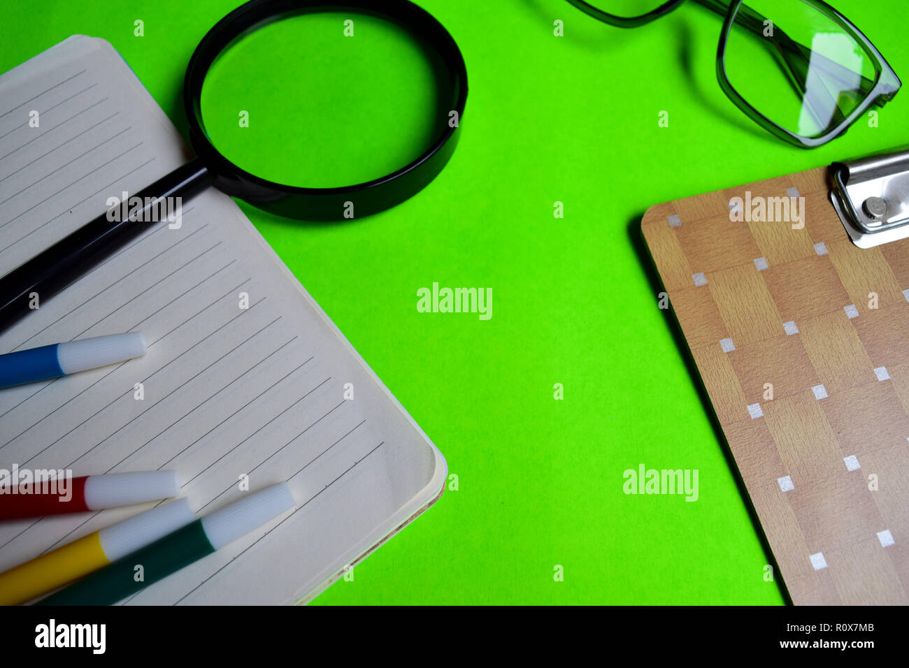 Notebook in green background with motivation and education concepts ...