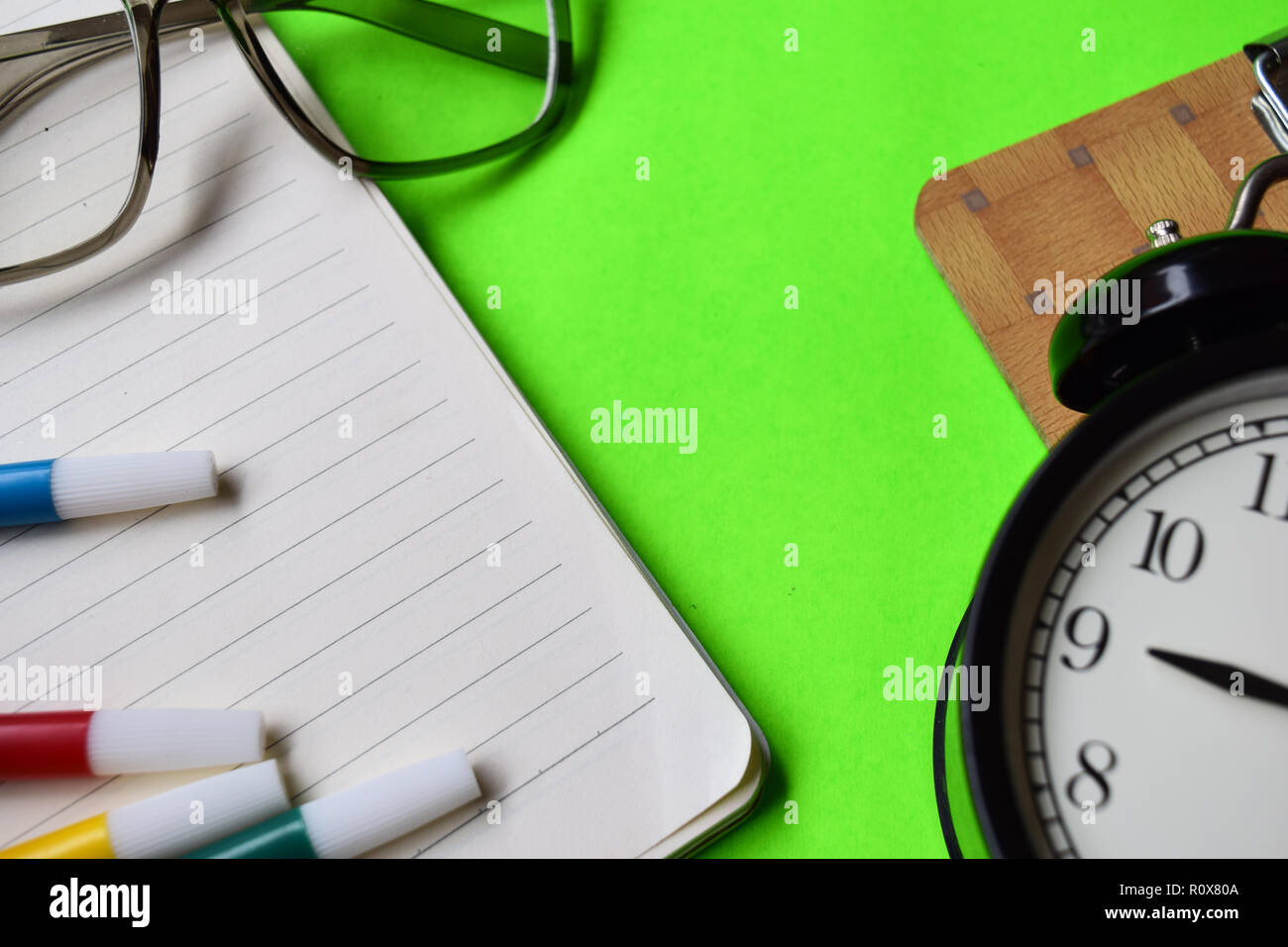 Notebook in green background with motivation and education concepts ...