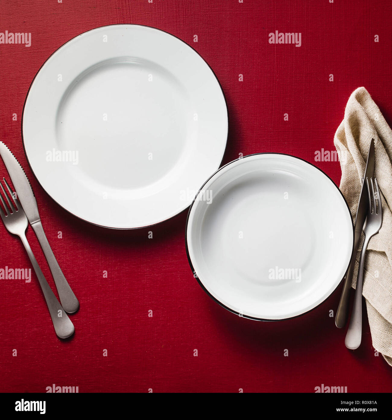 empty dining table set for two. two aluminum plates on a raspberry ...