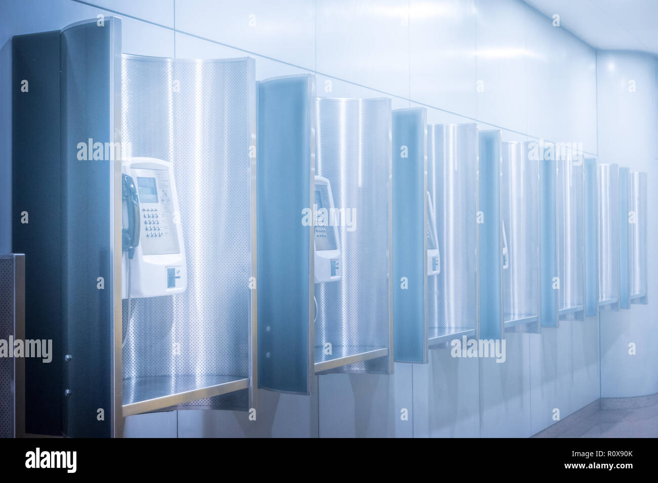 Perspective row of public telephone inside modern building Stock Photo ...