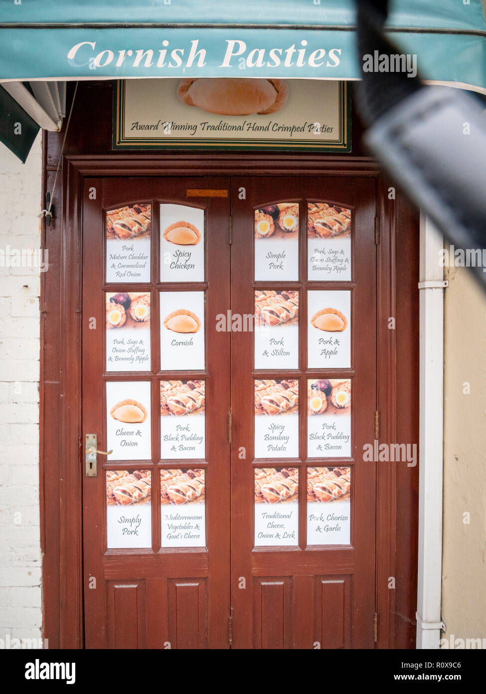 The window of a Cornish Pasty Shop in Ilfracombe Devon with adverts for ...