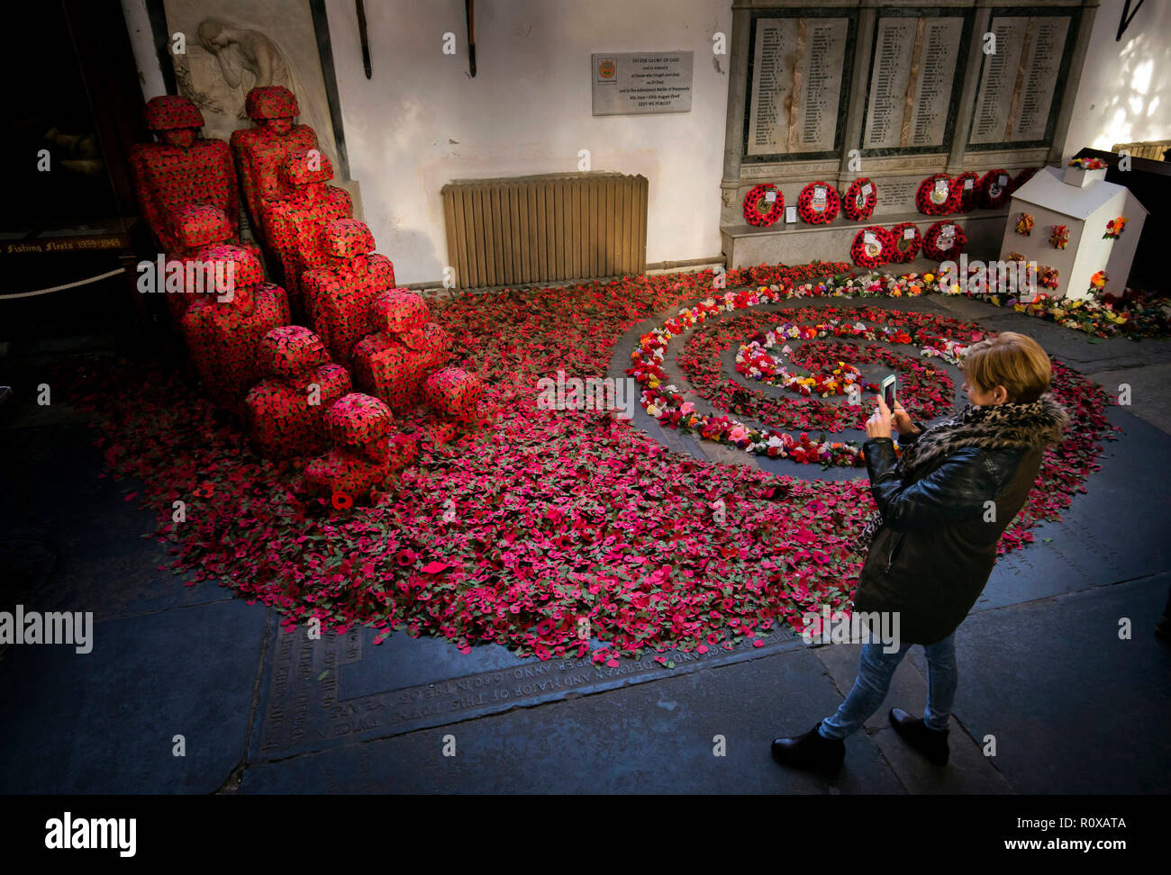 A woman takes a photograph of an installation titled Coming Home by ...