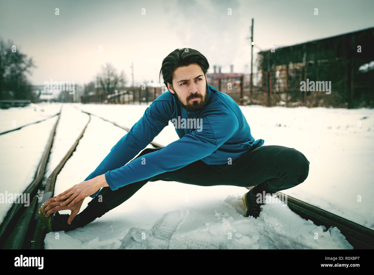 Young man crouching hi-res stock photography and images - Alamy