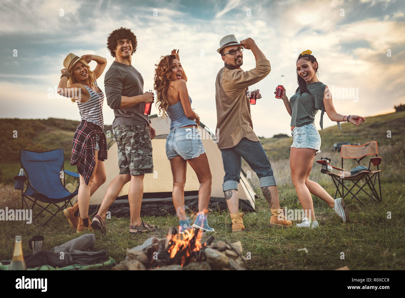 Happy young friends enjoy a nice day in nature. They're looking at ...