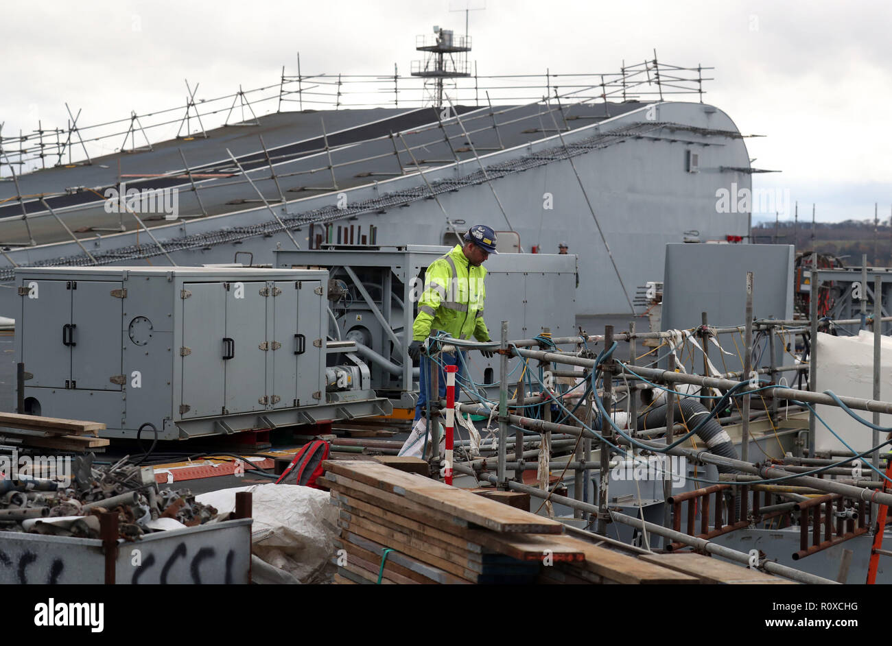 Work continues on the flight deck during a tour of the under ...
