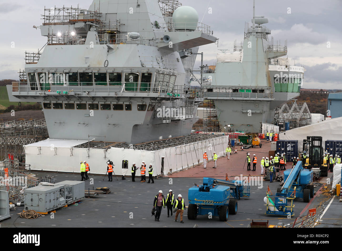 Work continues on the flight deck during a tour of the under ...