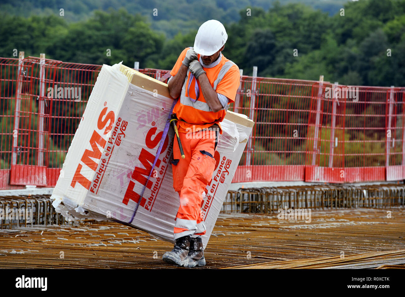 Worker carrying Polyurethane foam slabs - Work Site - France Stock ...
