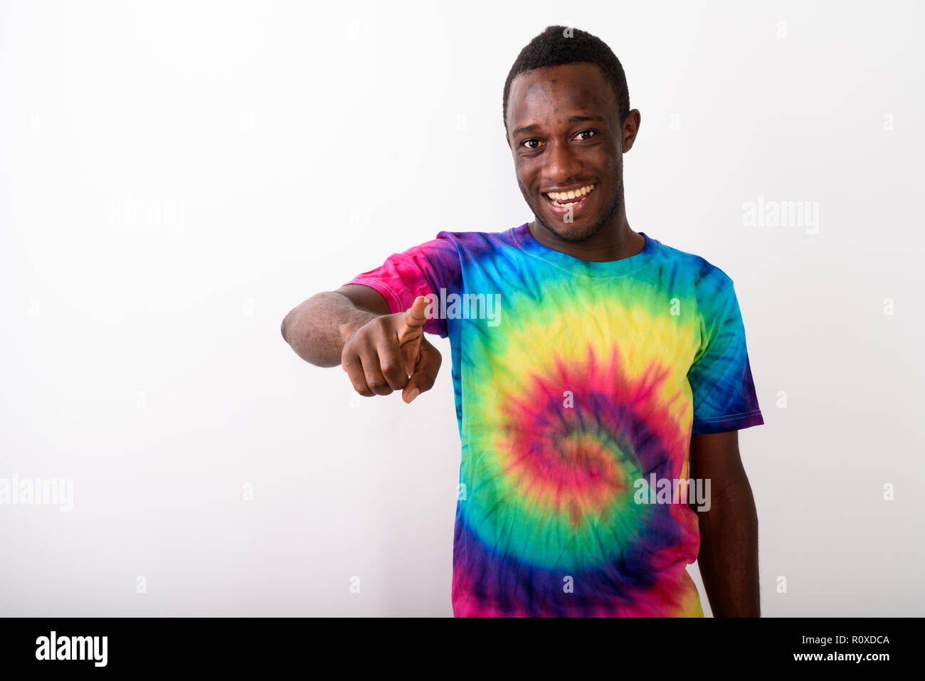 Studio shot of young happy black African man pointing finger at Stock ...