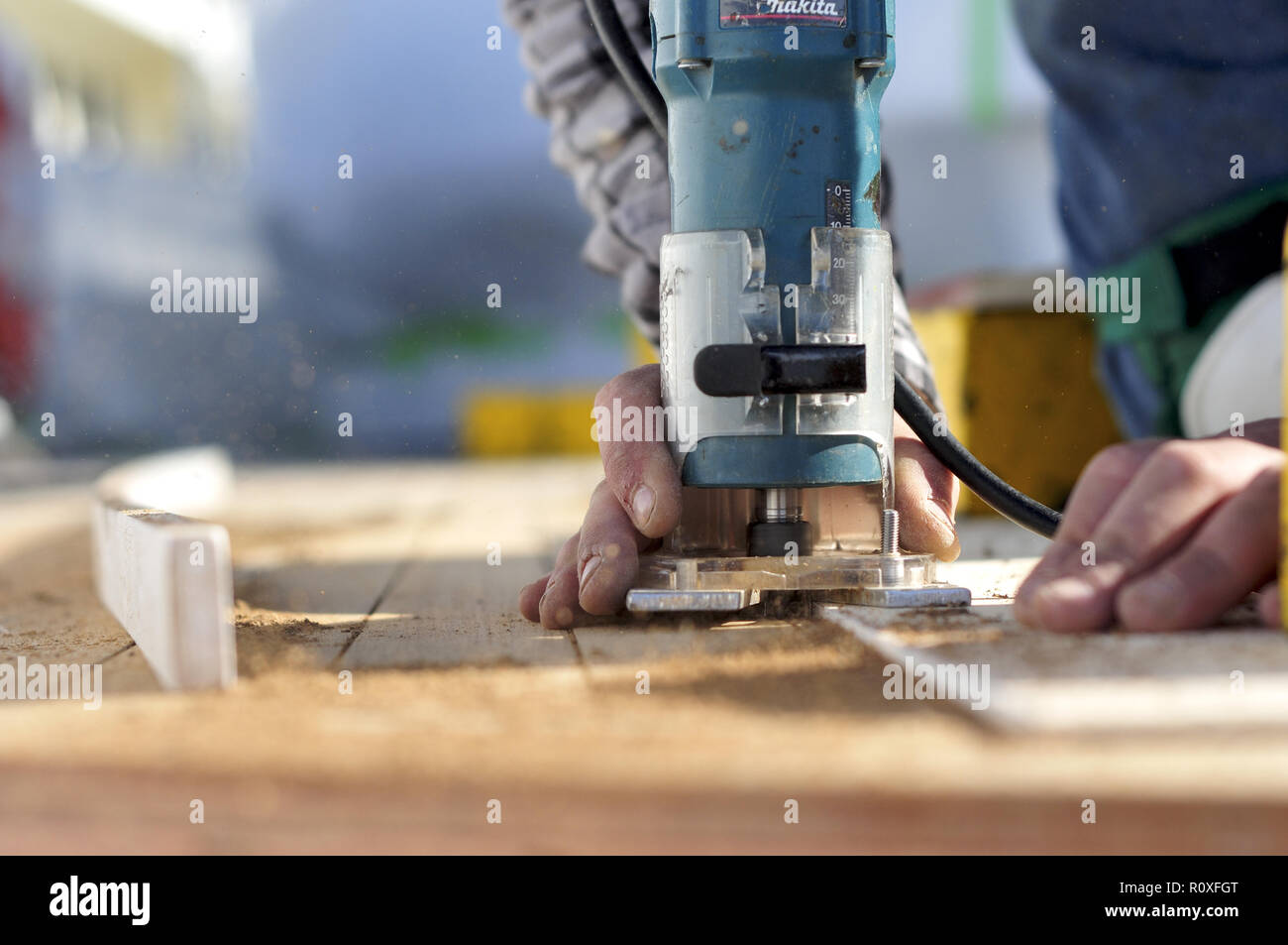 A worker sanding a boat deck Stock Photo - Alamy