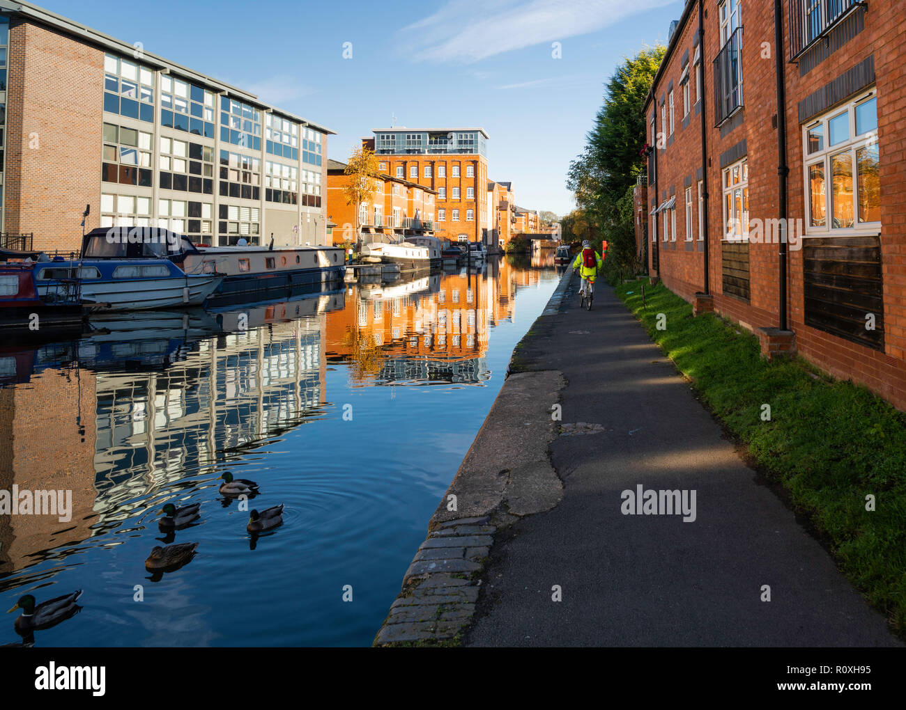 Reflections of barges and canal side buildings in the water at Diglis ...