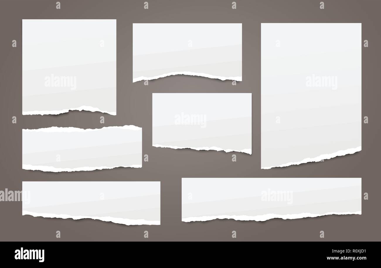 White note, notebook paper strips with torn edges stuck on dark brown ...