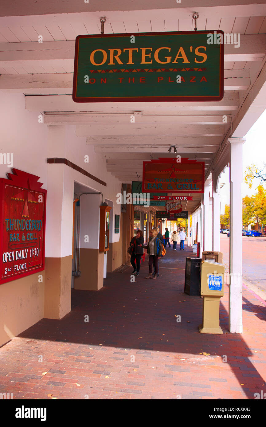 Overhead store signs above the sidewalk along Lincoln Ave on the Plaza ...