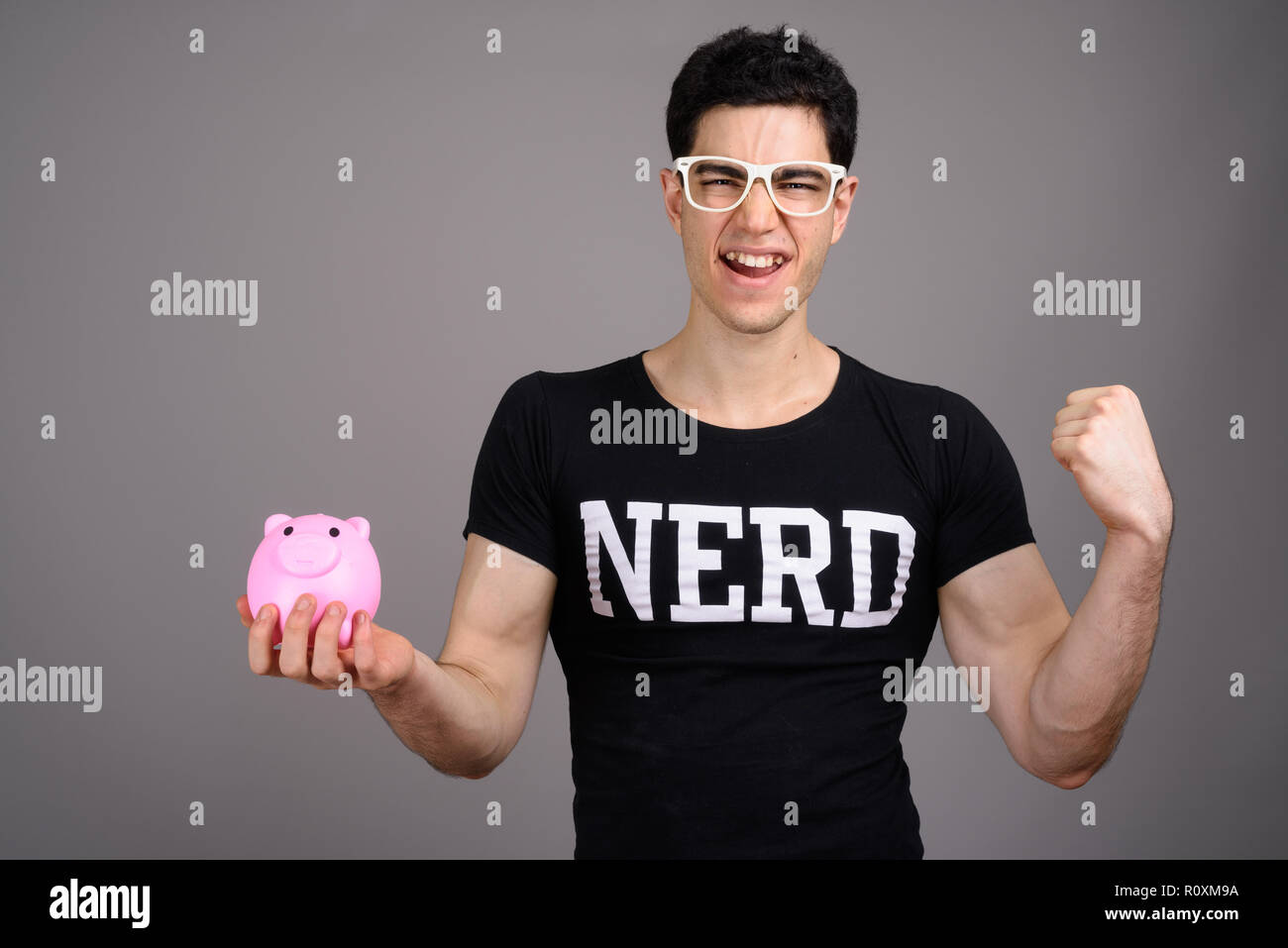 Young handsome nerd man with eyeglasses against gray background Stock ...