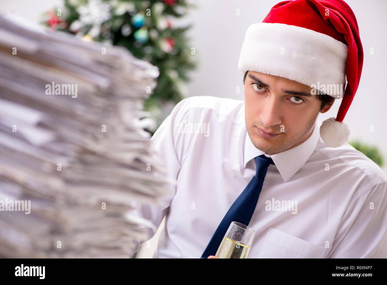 Young worker working in office on christmas shift Stock Photo - Alamy