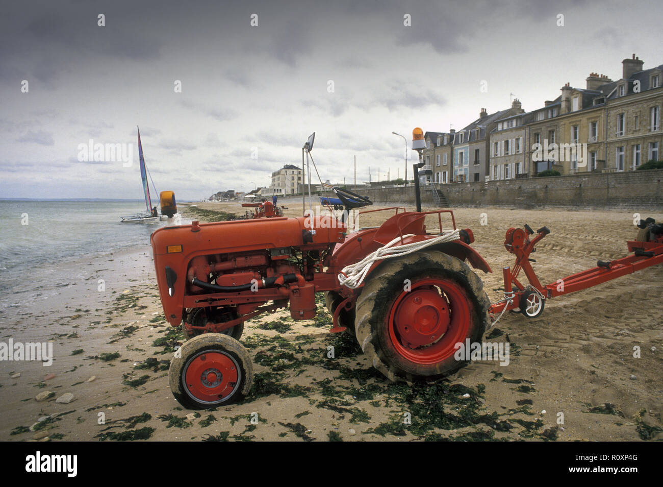 An old tractor used a boat launcher on the beach by Rue de la Plage in ...