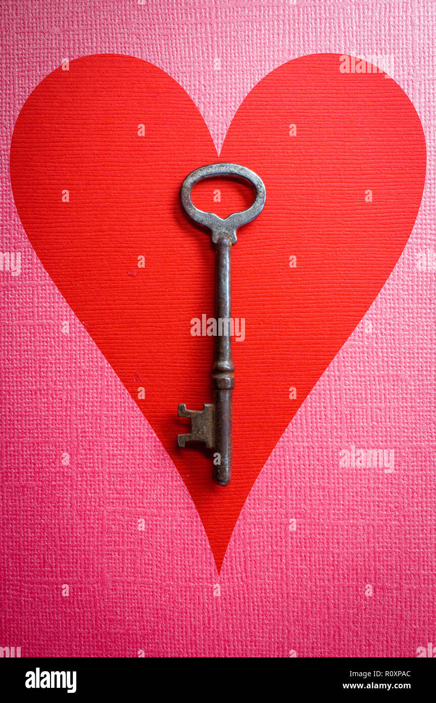 Old antique skeleton key to love with heart paper background Stock ...