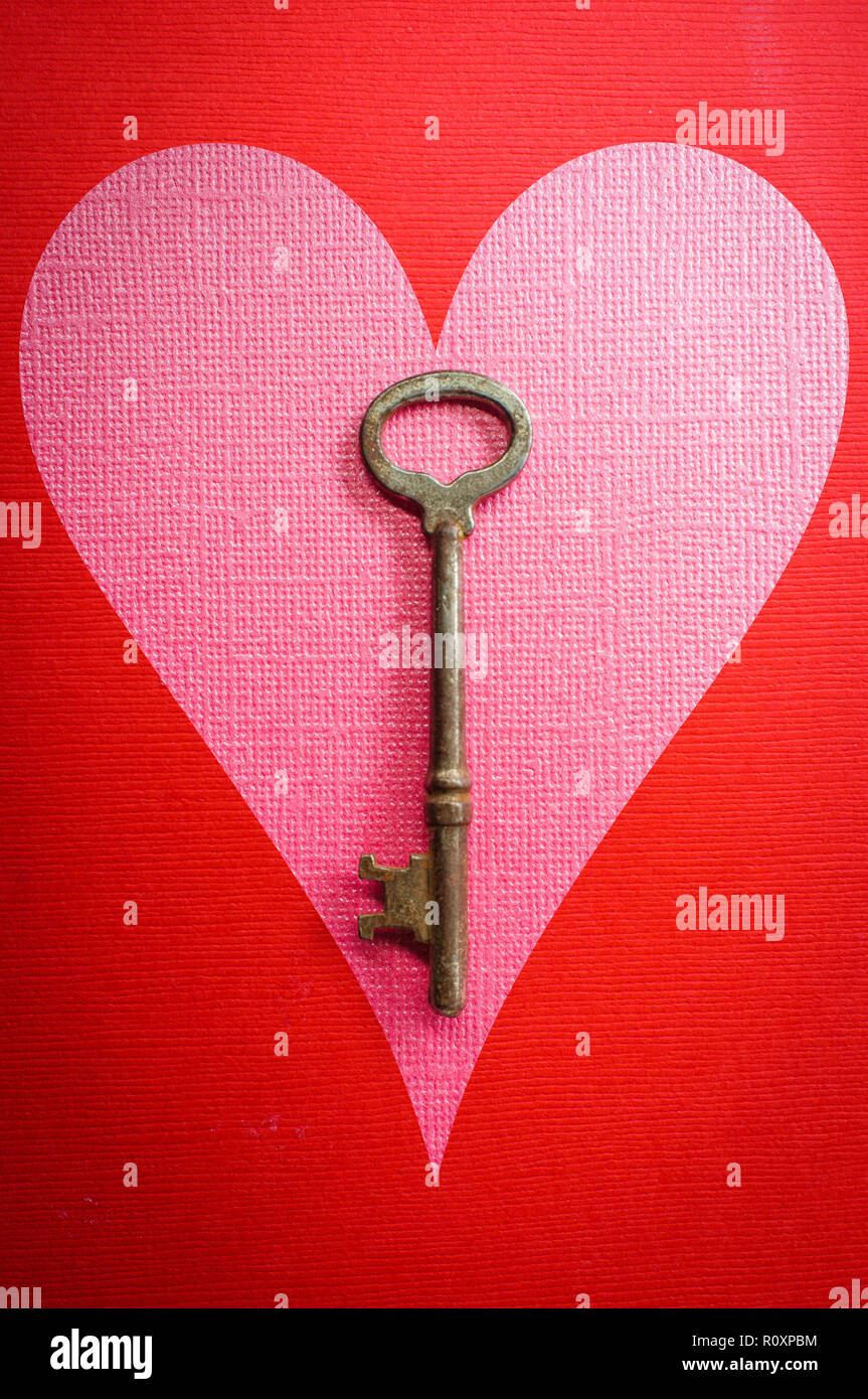 Old antique skeleton key to love with heart paper background Stock ...