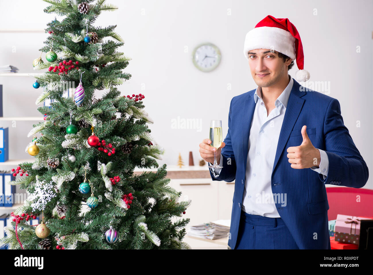 Young employee celebrating christmas at workplace Stock Photo - Alamy