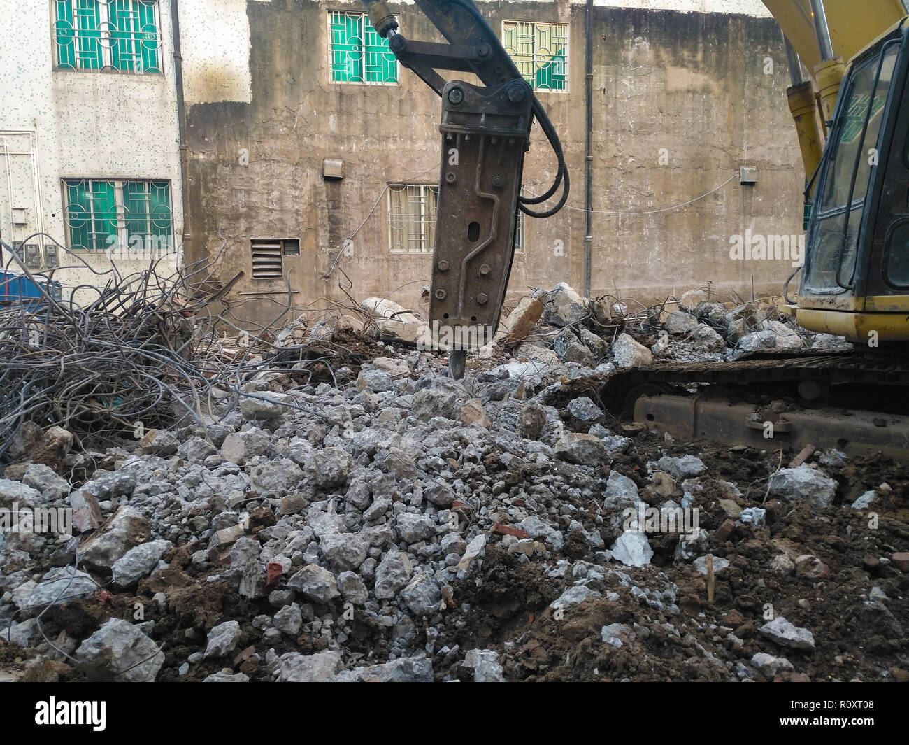 demolished concrete and brick rubble debris with excavator Stock Photo ...