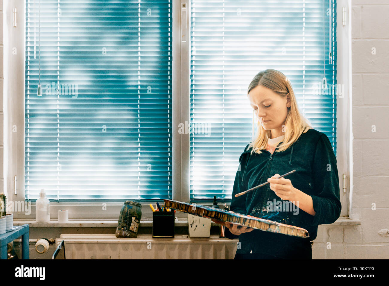 portrait of a female artist painter working in her studio atelier Stock ...