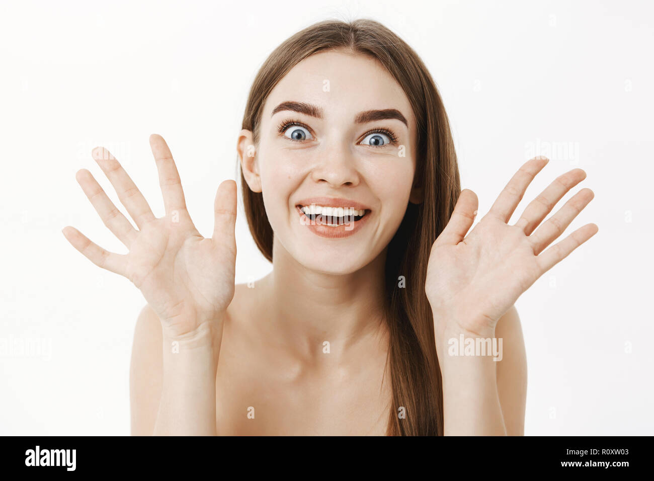 Woman reacting to own look in mirror without no makeup feeling ...