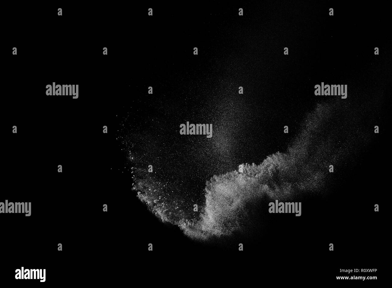 Freeze motion of white particles on black background. Powder explosion ...