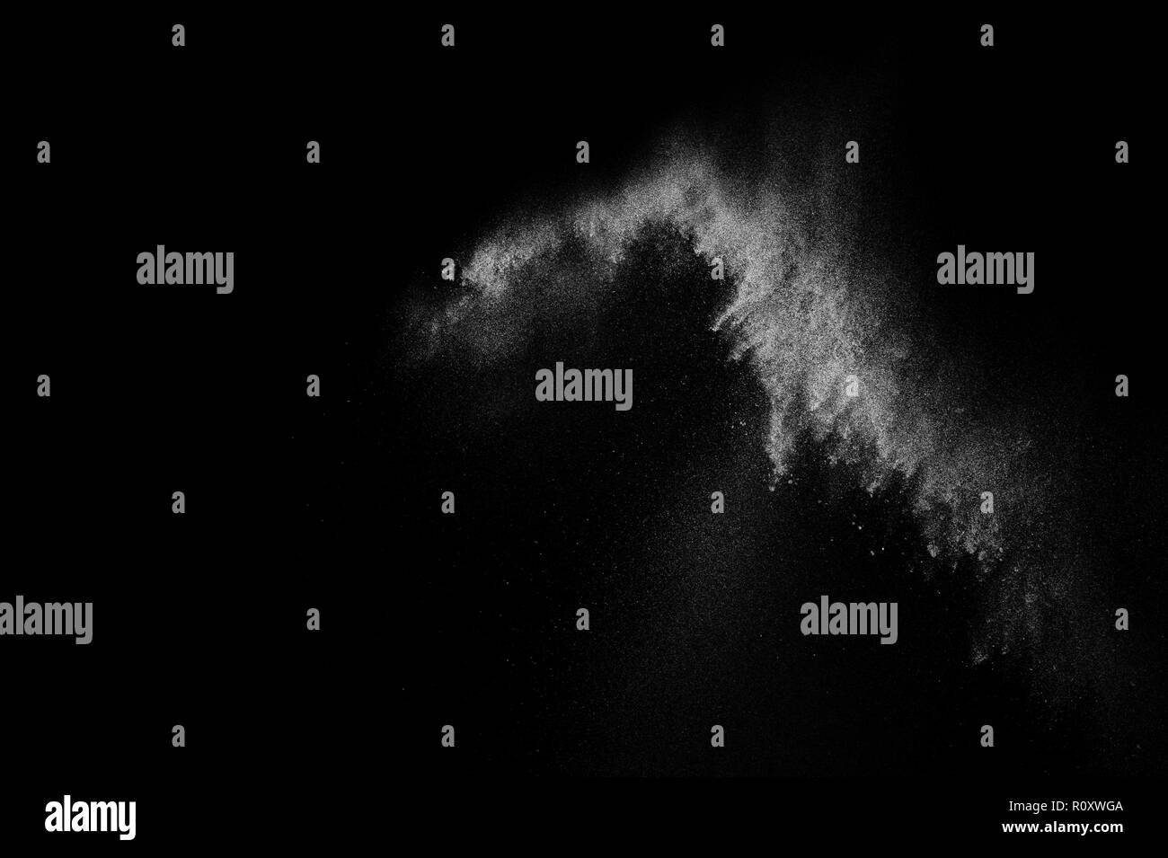 Freeze motion of white particles on black background. Powder explosion ...