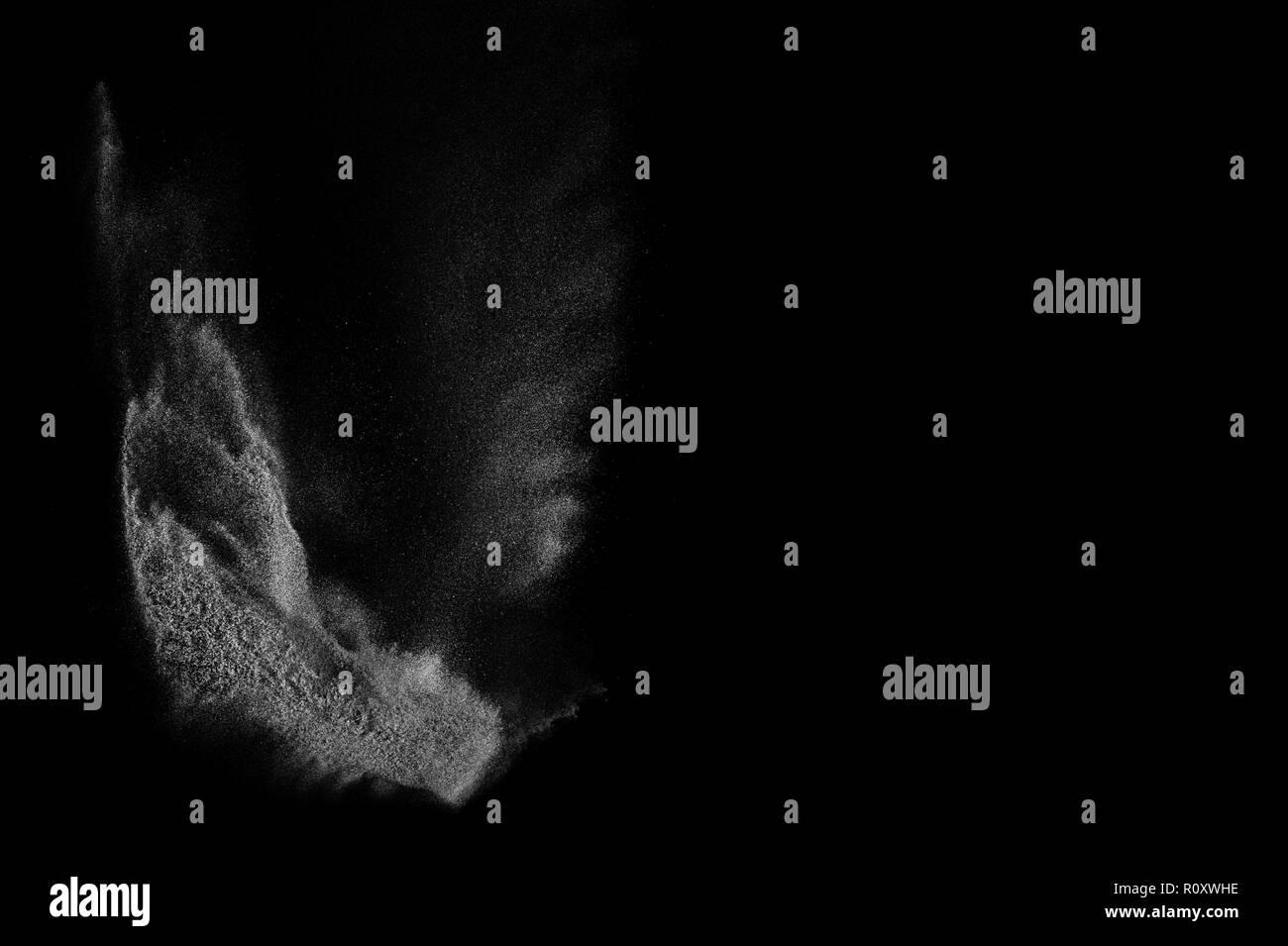 Freeze motion of white particles on black background. Powder explosion ...