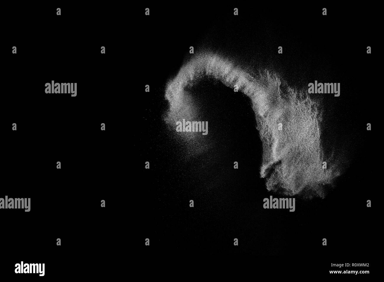 Freeze motion of white particles on black background. Powder explosion ...