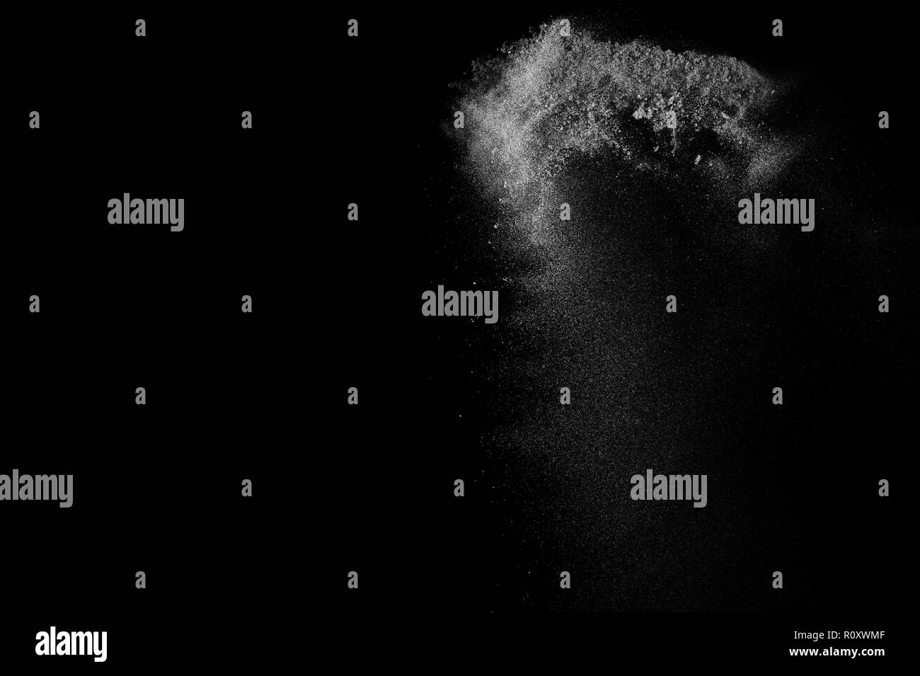 Freeze motion of white particles on black background. Powder explosion ...