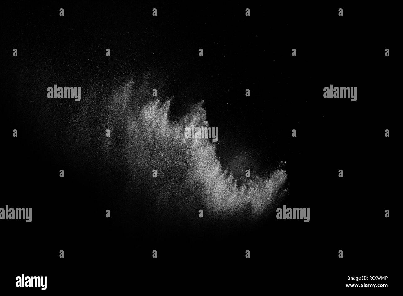 Freeze motion of white particles on black background. Powder explosion ...