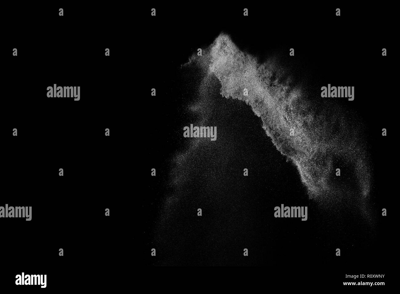 Freeze motion of white particles on black background. Powder explosion ...