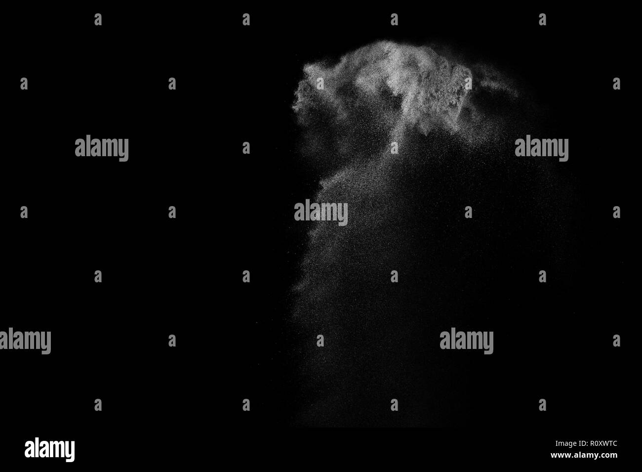 Freeze motion of white particles on black background. Powder explosion ...