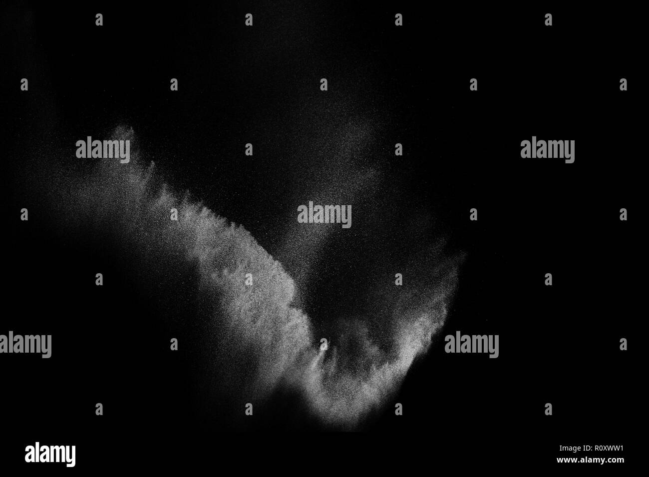 Freeze motion of white particles on black background. Powder explosion ...