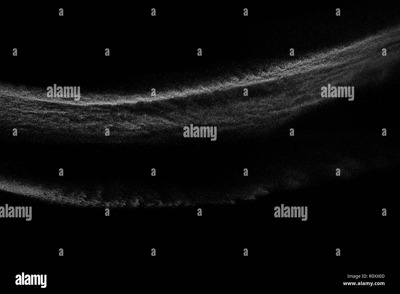 Freeze motion of white particles on black background. Powder explosion ...
