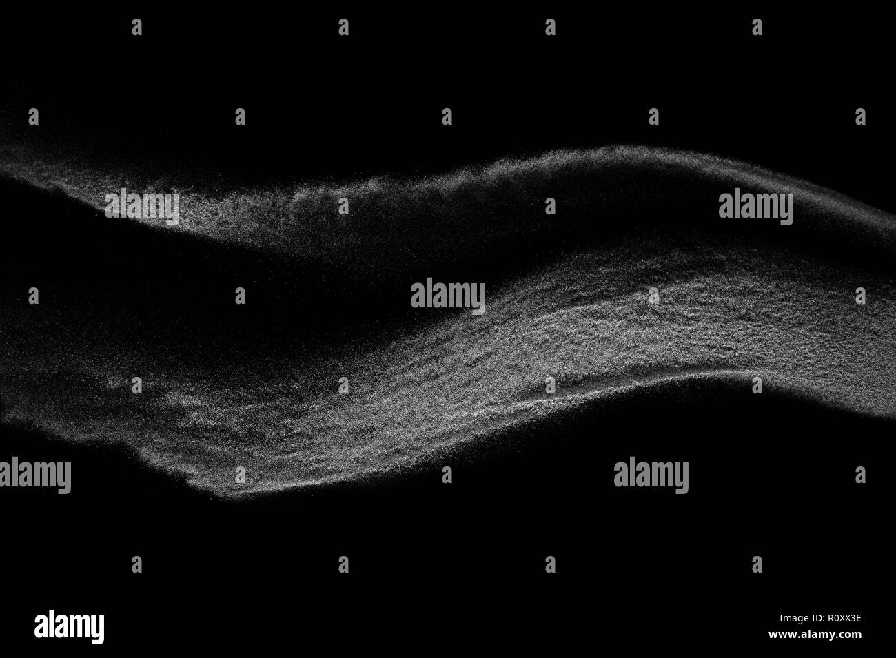 Freeze motion of white particles on black background. Powder explosion ...